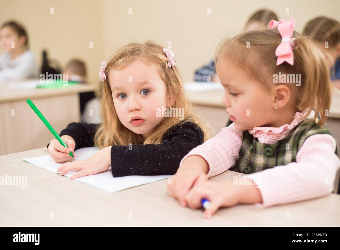 Group of elementary pupils in the classroom Stock Photo - Alamy