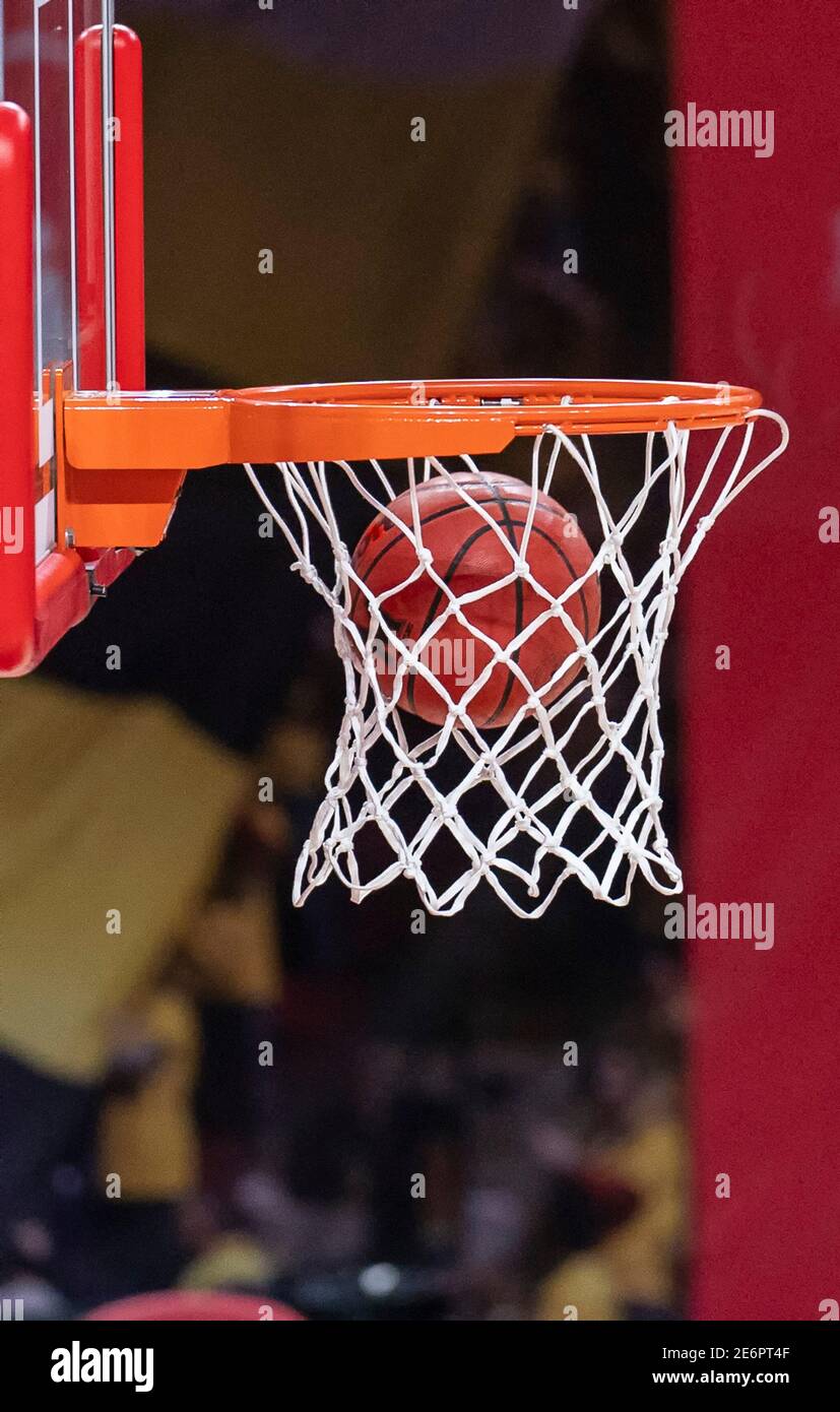 Basketball about to slip through the net Stock Photo - Alamy