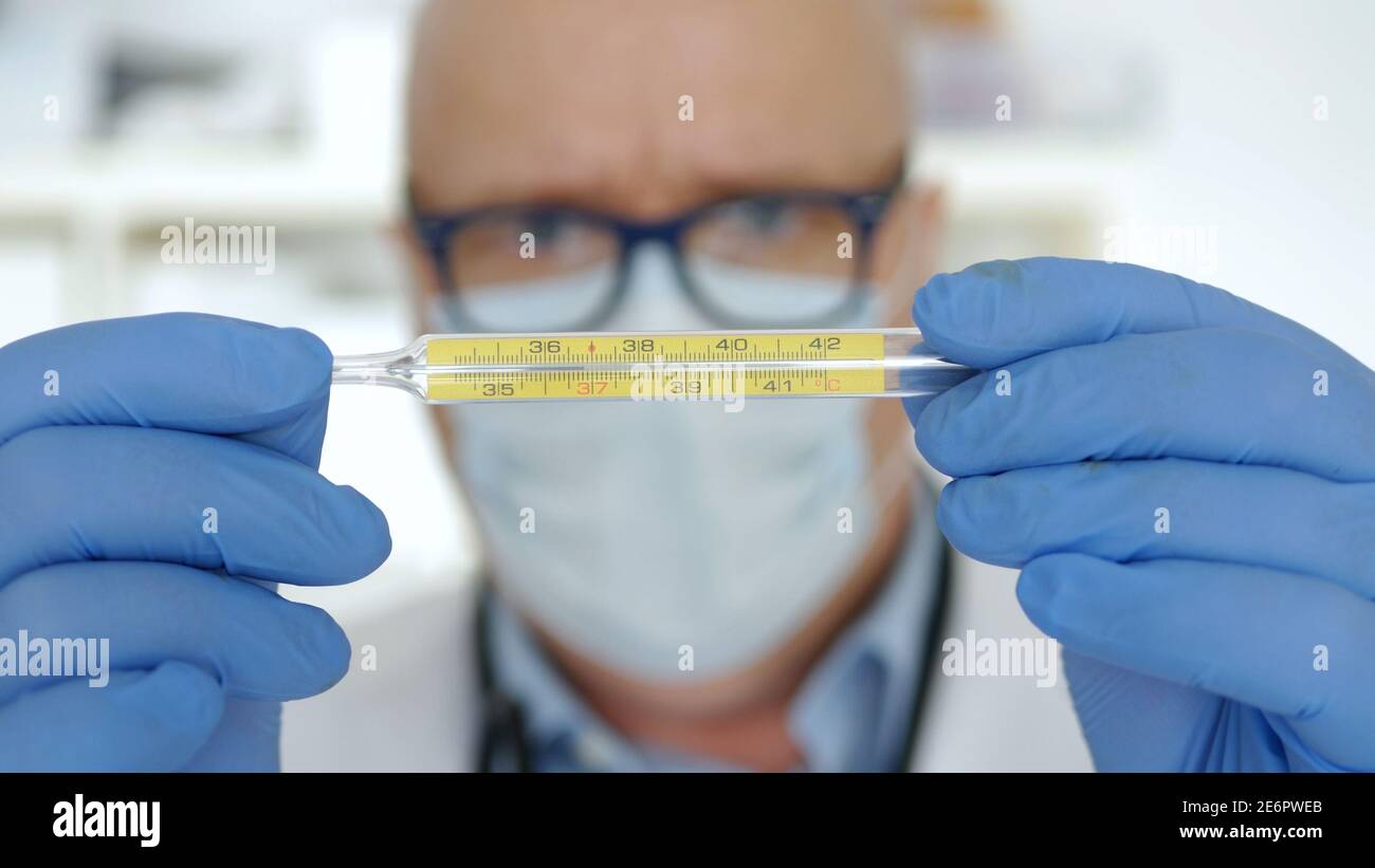 Doctor Wearing Protection Gloves and Face Mask Keep in His Hand a ...