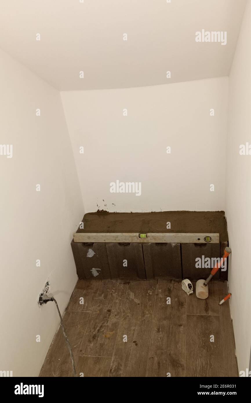 Installing a safe in the house, the master makes measurements to ...