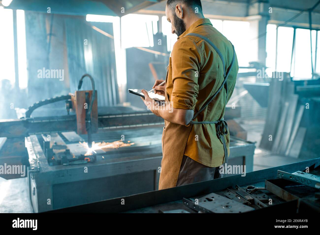 Heavy industry worker controlling the process of metal cutting Stock ...