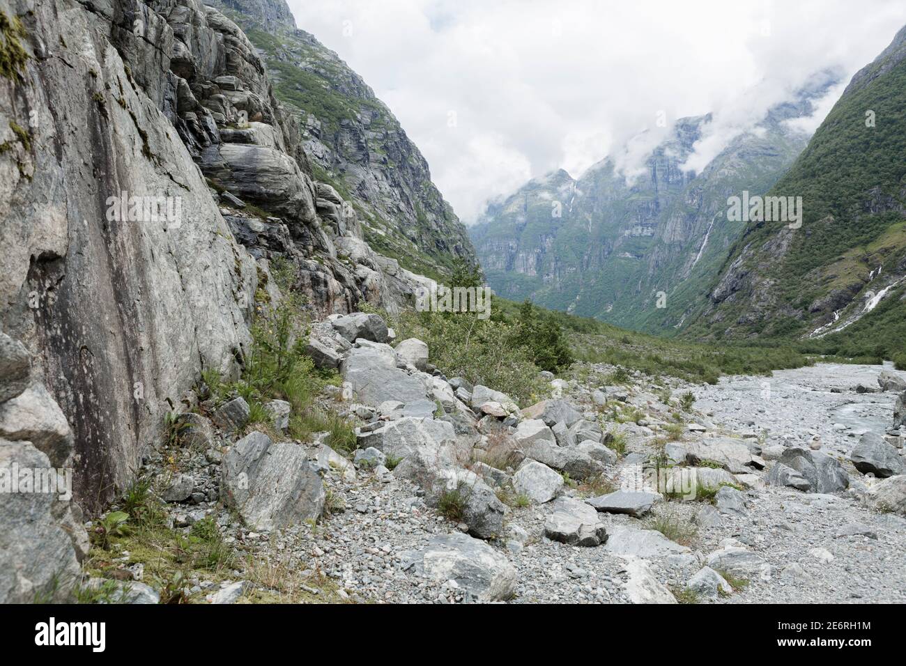 Rocky terrain and clouds hanging in the forested mountains at ...