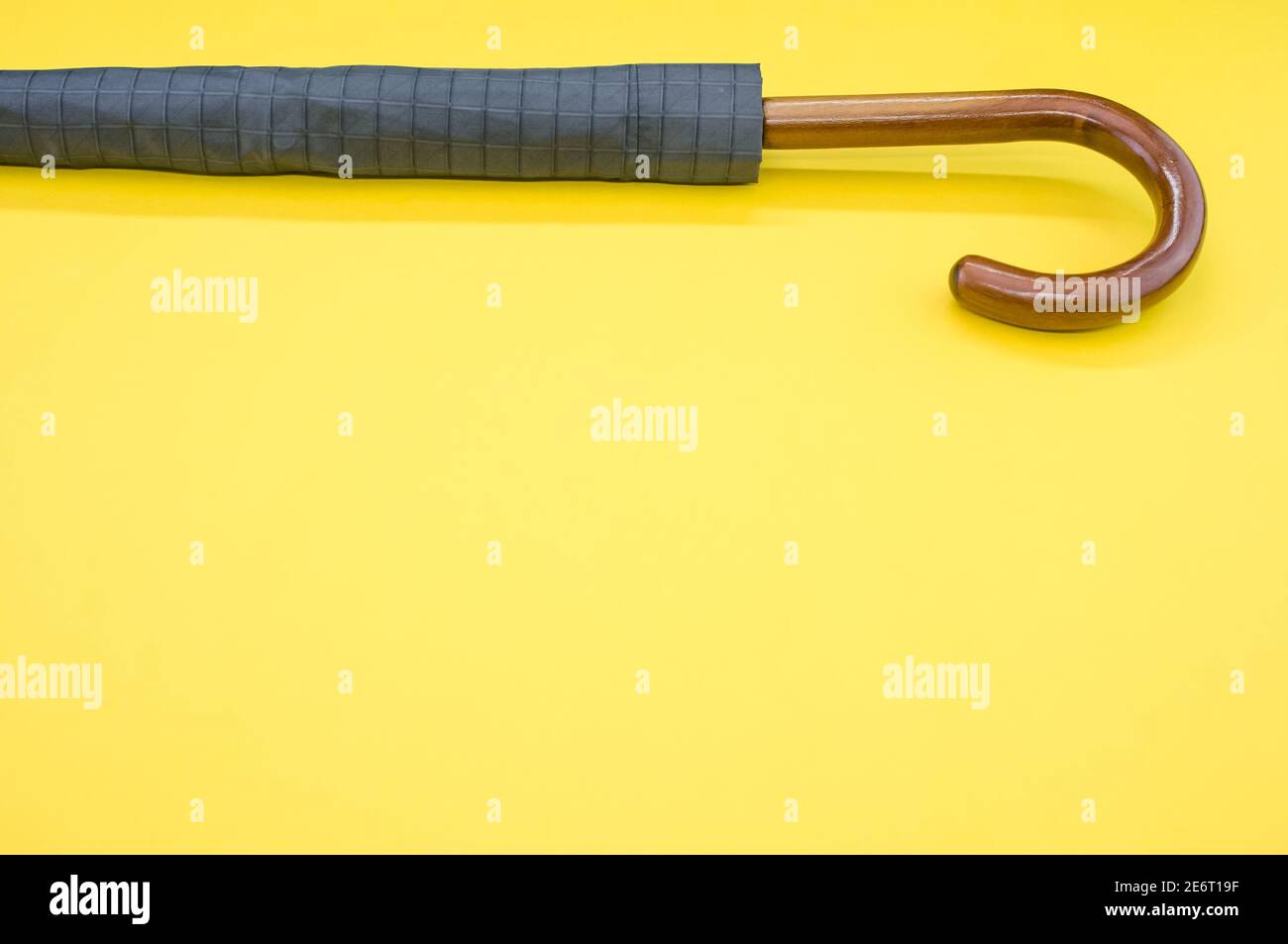 Closeup shot of a wooden umbrella handle isolated on a yellow ...