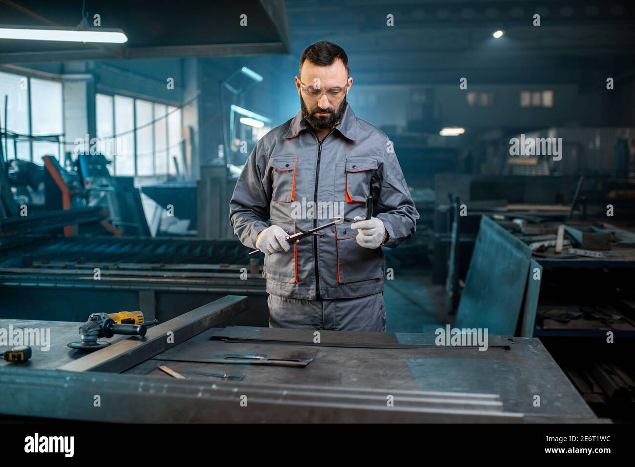 Metal industry worker at factory in work wear Stock Photo - Alamy