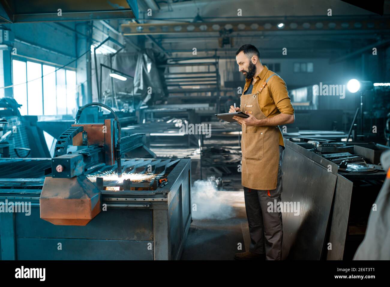 Heavy industry worker controlling the process of metal cutting Stock ...