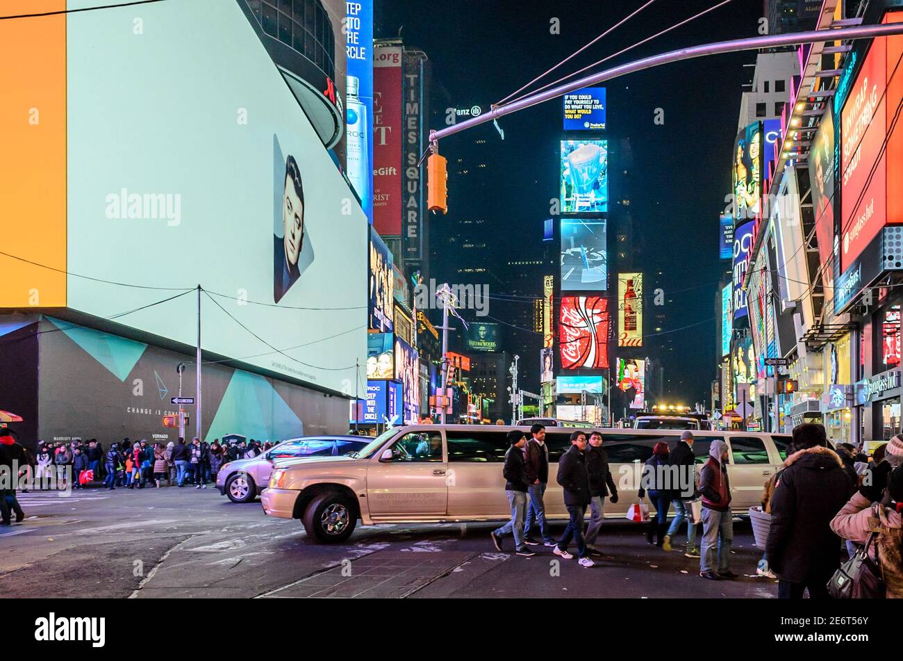 Times Square at Night. A Limousine and a lot of People Crossing the ...