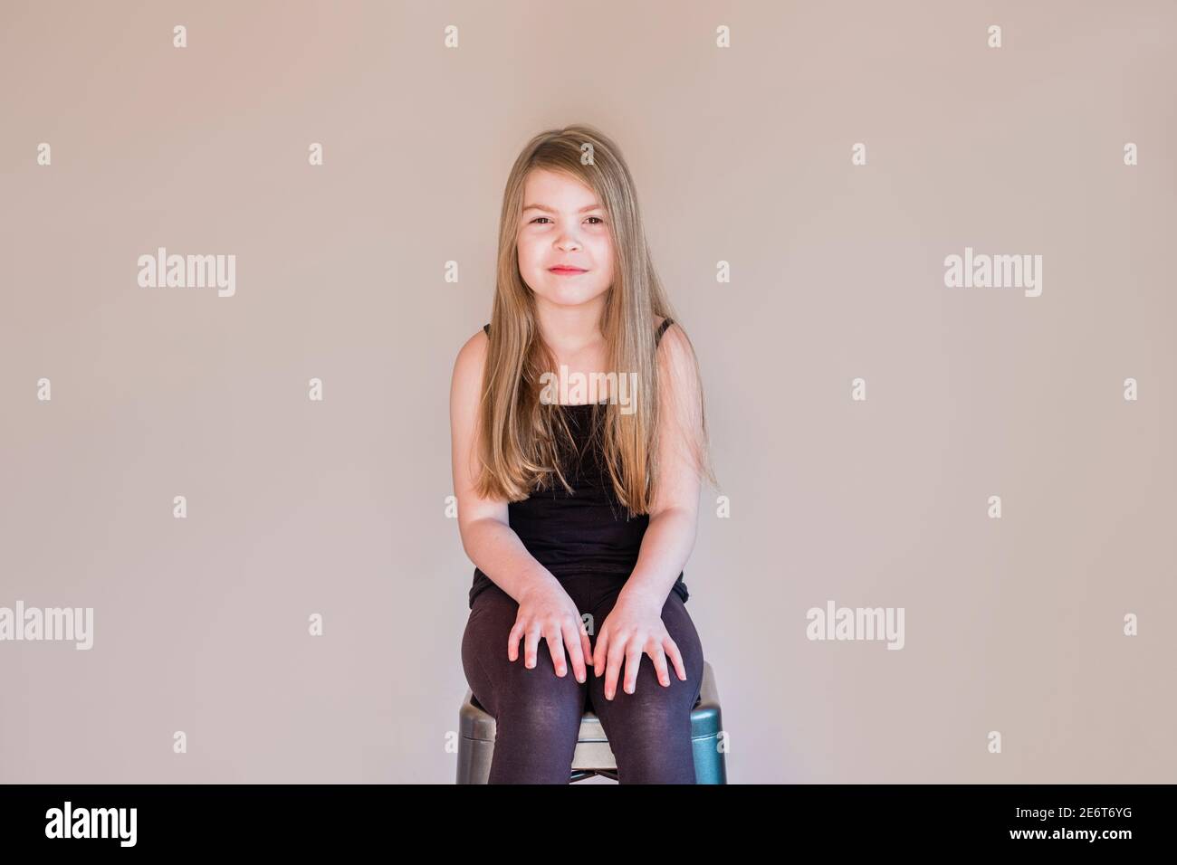 Girl sitting on stool hi-res stock photography and images - Alamy