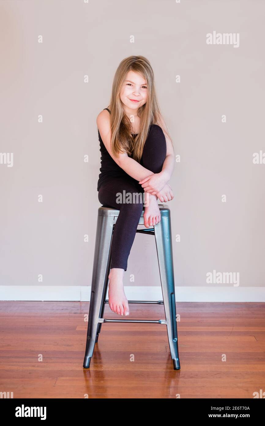 Young blonde female on stool hi-res stock photography and images - Alamy