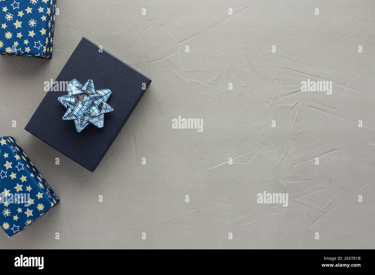 Blue gift box and boxes in blue beautiful wrapper with stars and a bows ...