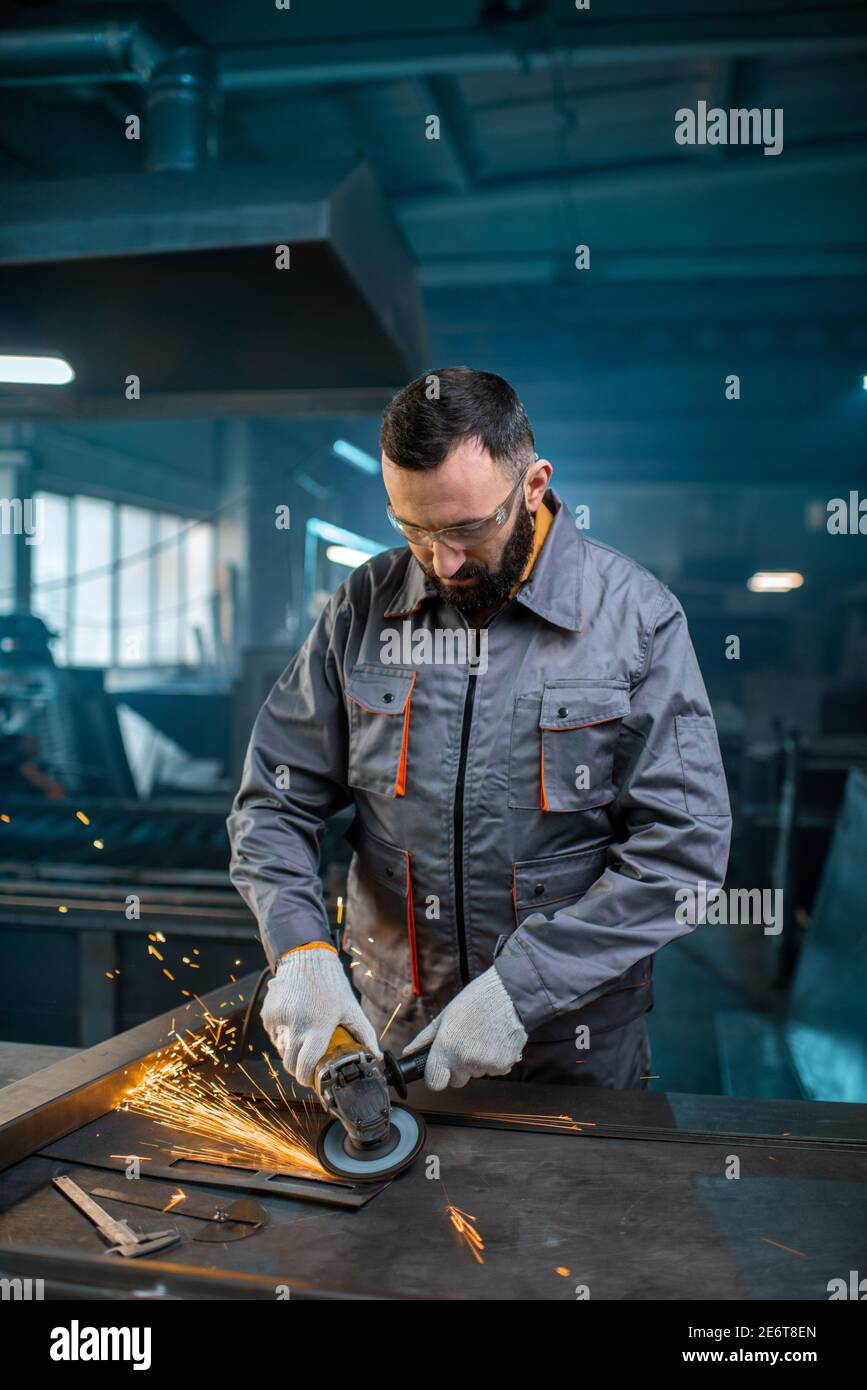 Metal industry worker at factory in work wear Stock Photo - Alamy