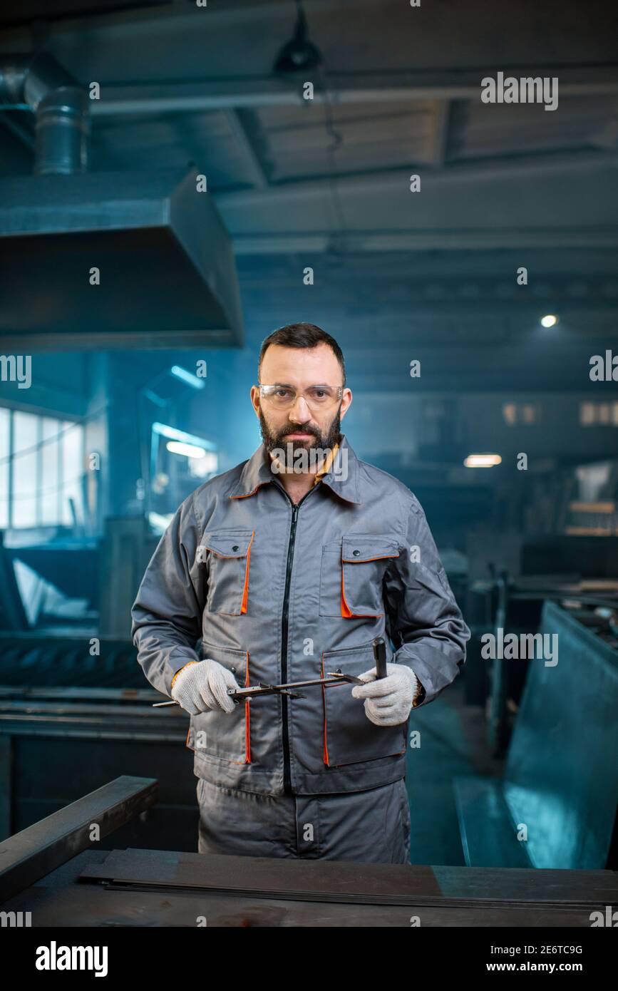 Metal industry worker at factory in work wear Stock Photo - Alamy