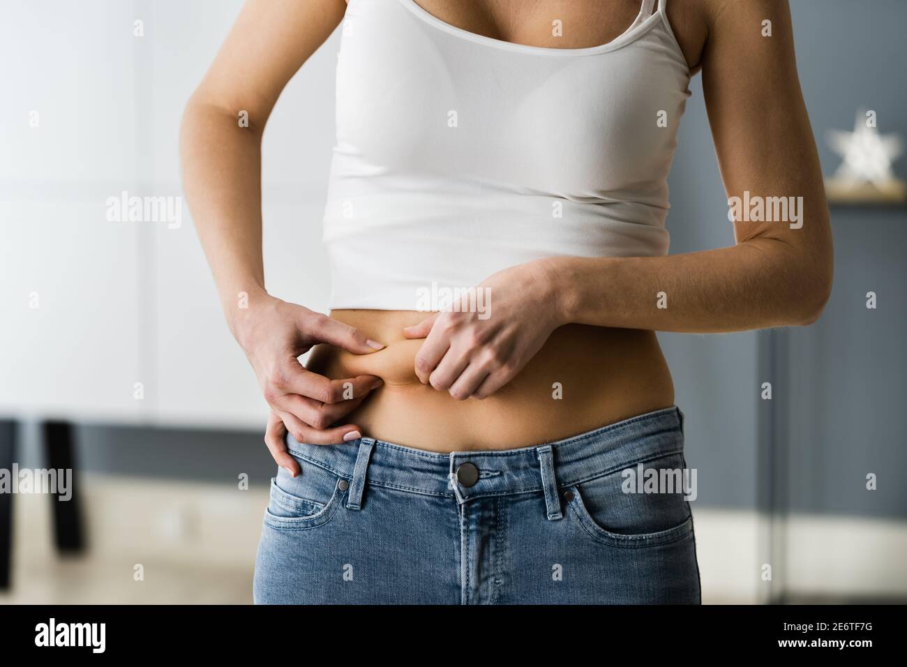 Stomach Fat Liposuction And Diet. Stomach Skin Pinch Stock Photo - Alamy