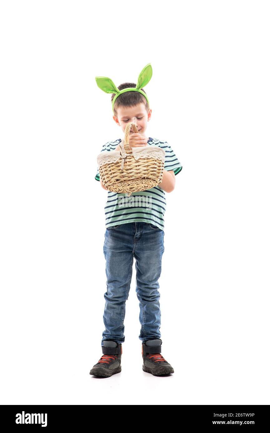 Happy cool young smiling kid holding Easter wicker basket looking ...