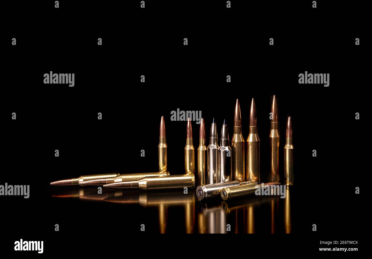 Bullet isolated on black background with reflexion. Rifle bullets close ...