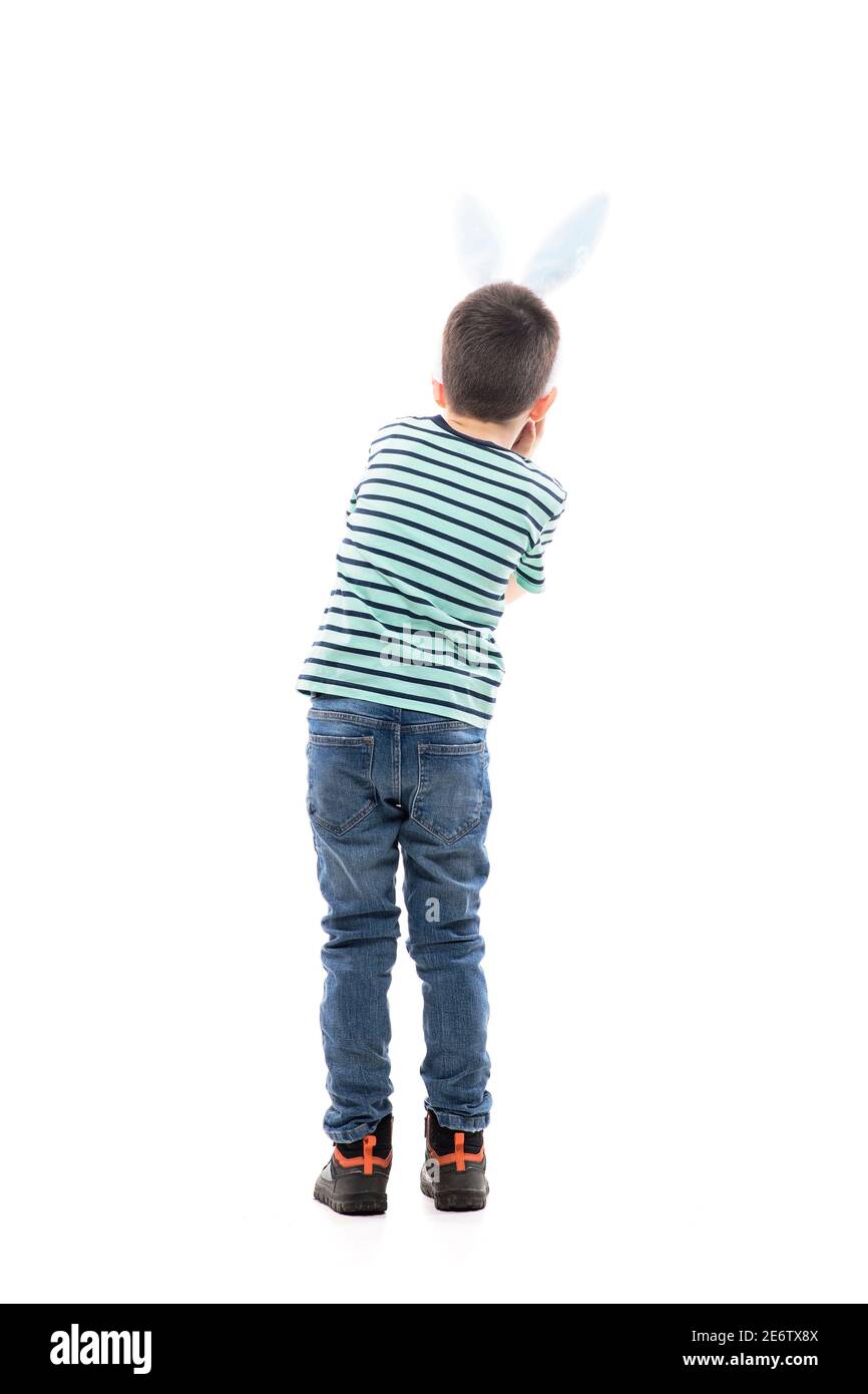 Back view of amazed fascinated young boy with Easter bunny ears ...