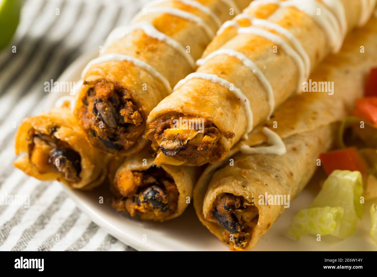 Homemade Mexican Chicken Flautas with Crema and Lettuce and Tomato ...