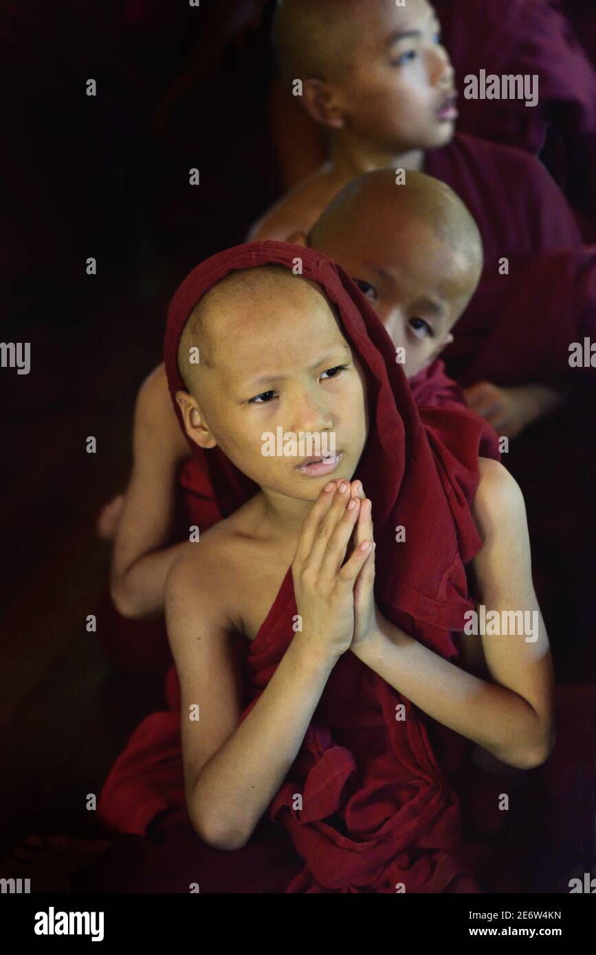 Myanmar (Burma), Bagan, Shwe Gu monastery, Novices in prayer prior to ...