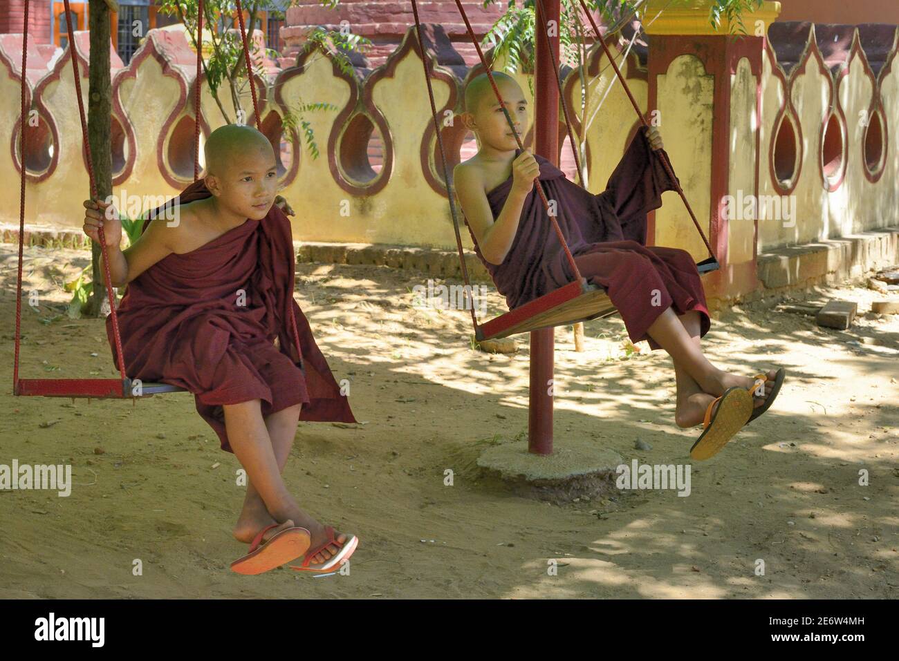 Myanmar (Burma), Bagan, Shwe Gu monastery, Buddhist novices on swings ...