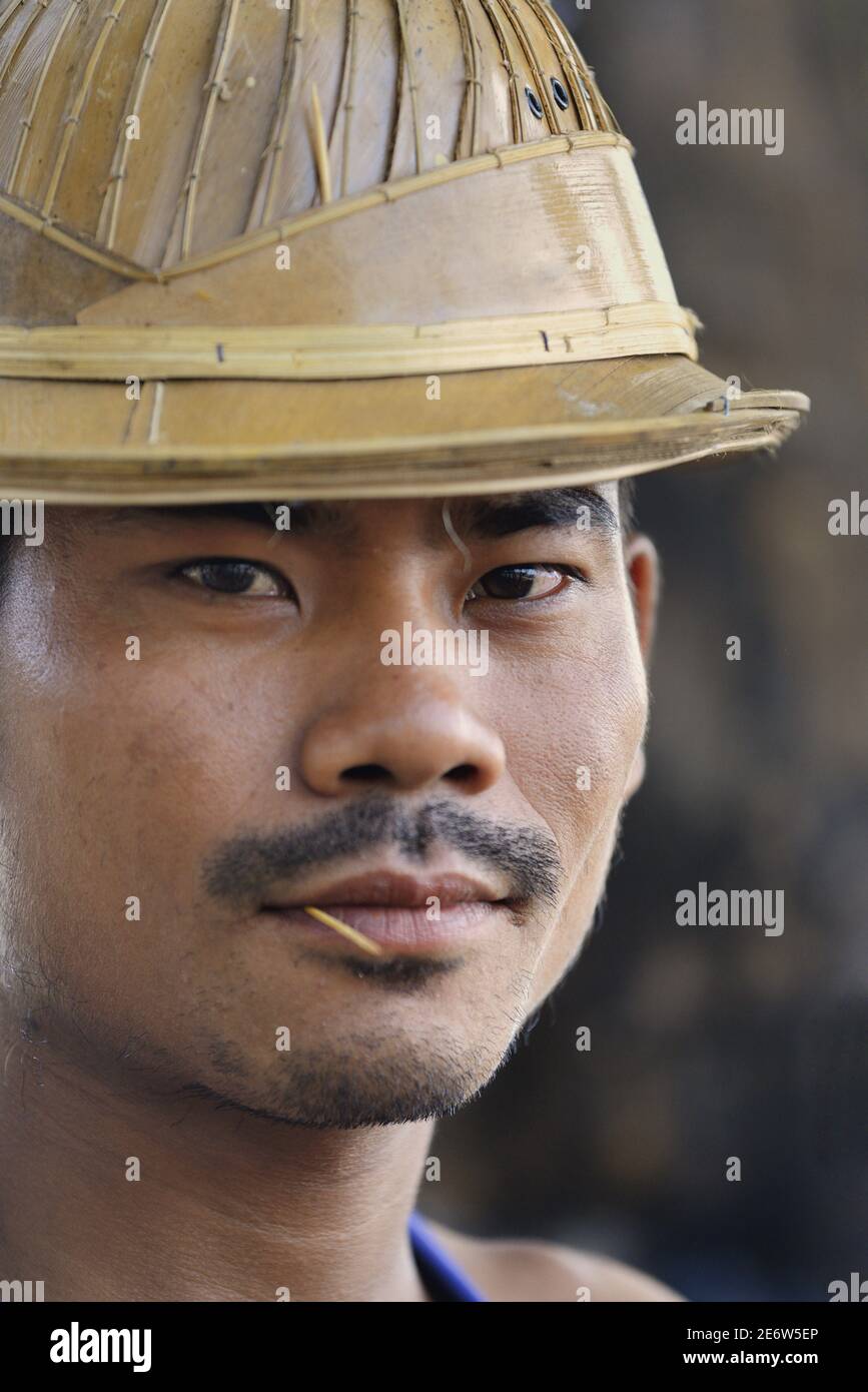 Myanmar (Burma), Yangon (Rangoon), Young man with traditional bamboo ...