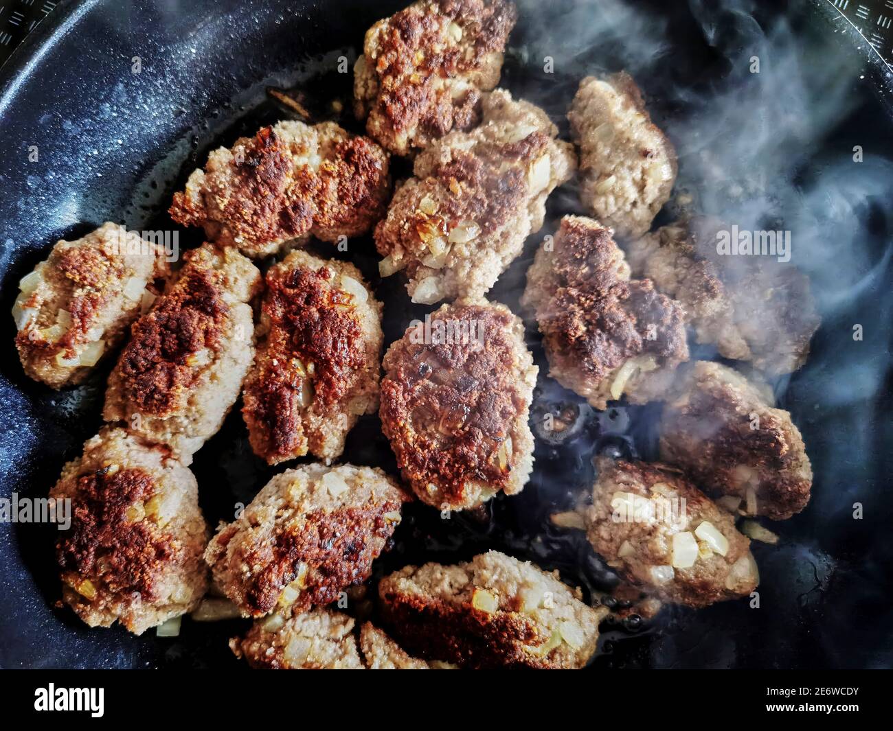 View to a pan with homemade traditional Berlin meatballs, with smoke ...