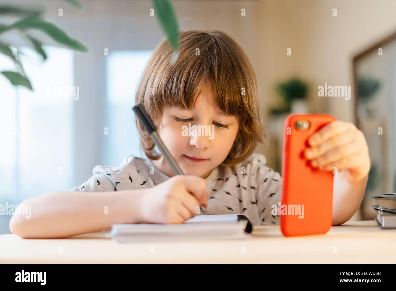 Back to school. Boy at home with phone Stock Photo - Alamy