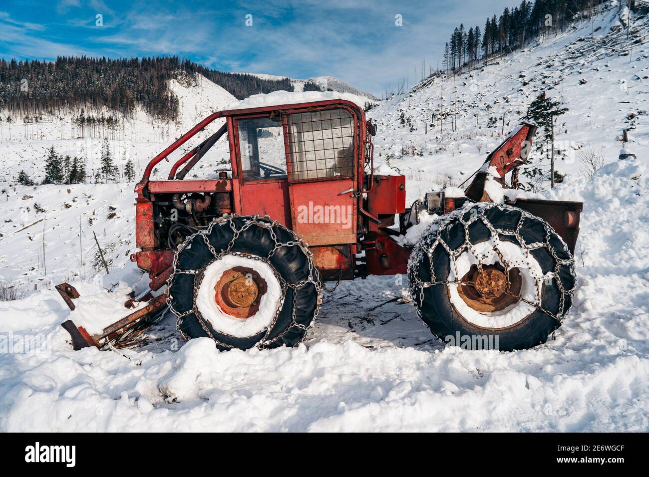 Winter scene in Europe, old tractor under the snow. Old Red farm ...
