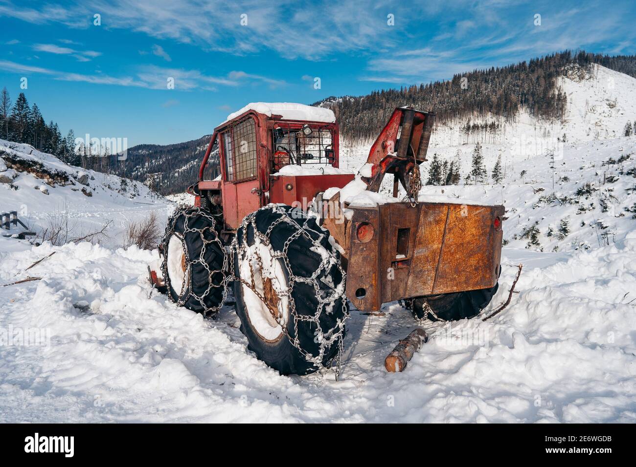 Winter scene in Europe, old tractor under the snow. Old Red farm ...