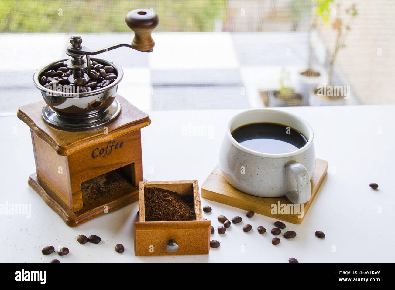 Coffee grinder and a cup of fresh coffee, morning coffee, energy drink ...