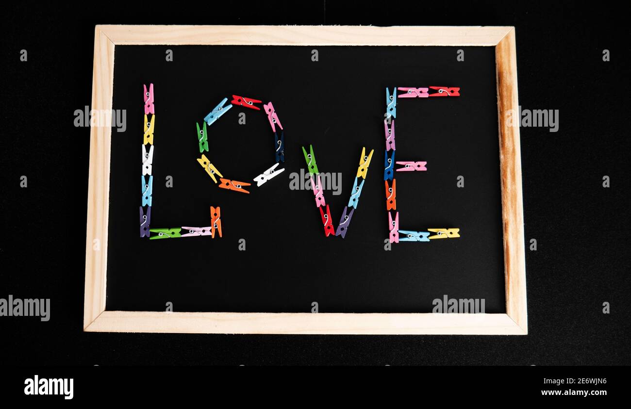 The word love from colorful clips on a black board Stock Photo - Alamy