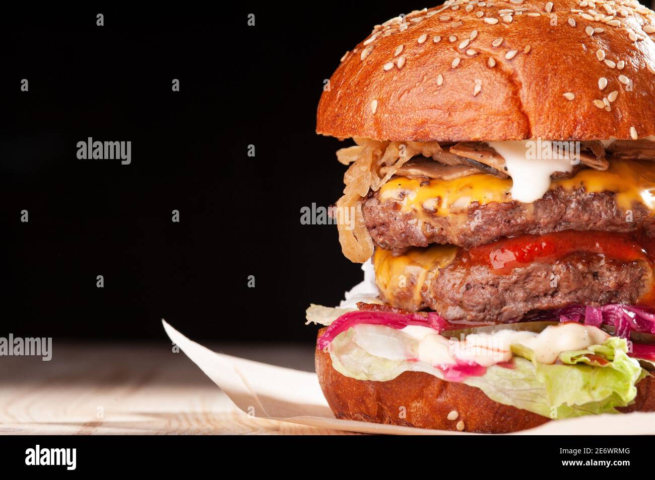 Closeup hamburger on black background in restaurant Stock Photo - Alamy
