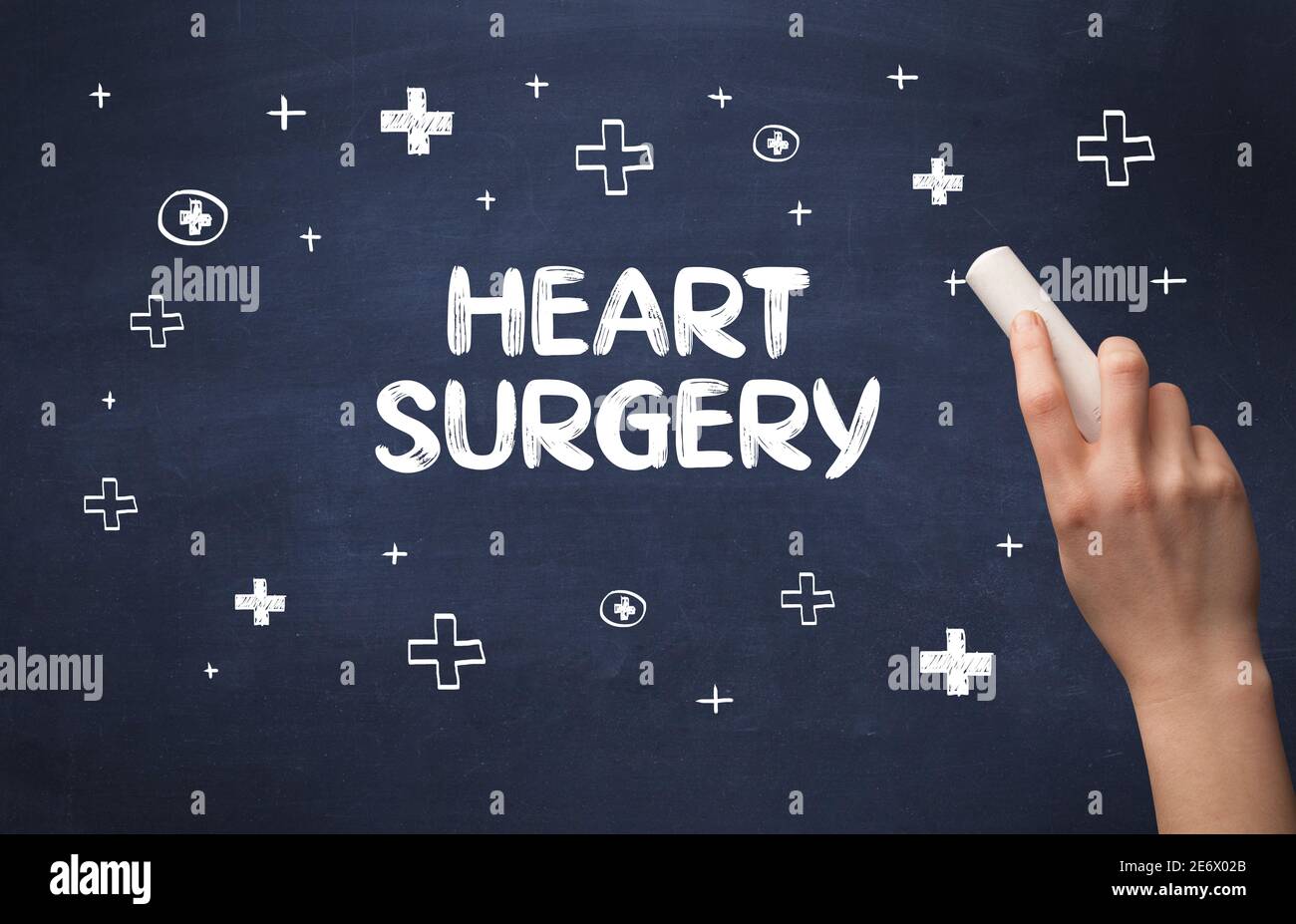 Hand drawing HEART SURGERY inscription with white chalk on blackboard ...