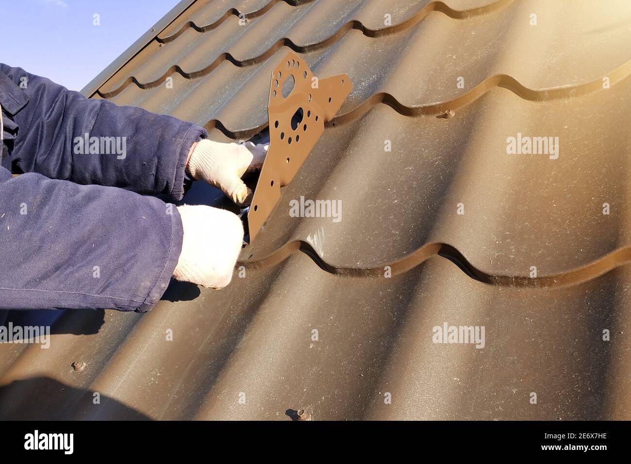 The worker works at height, attaches snow-cutting elements to the ...