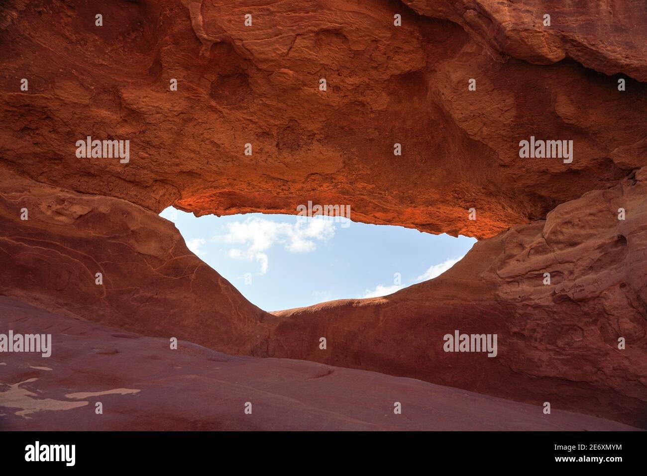 Little arc or small rock window formation in Wadi Rum desert, blue sky ...