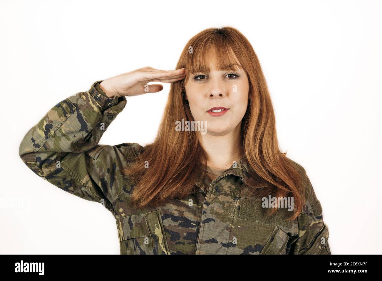 Woman wearing military camouflage giving a military hand salute with a ...