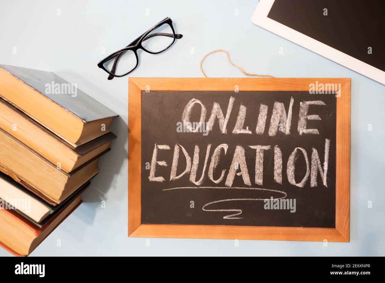Chalk board - online learning, tablet and a stack of books Stock Photo ...