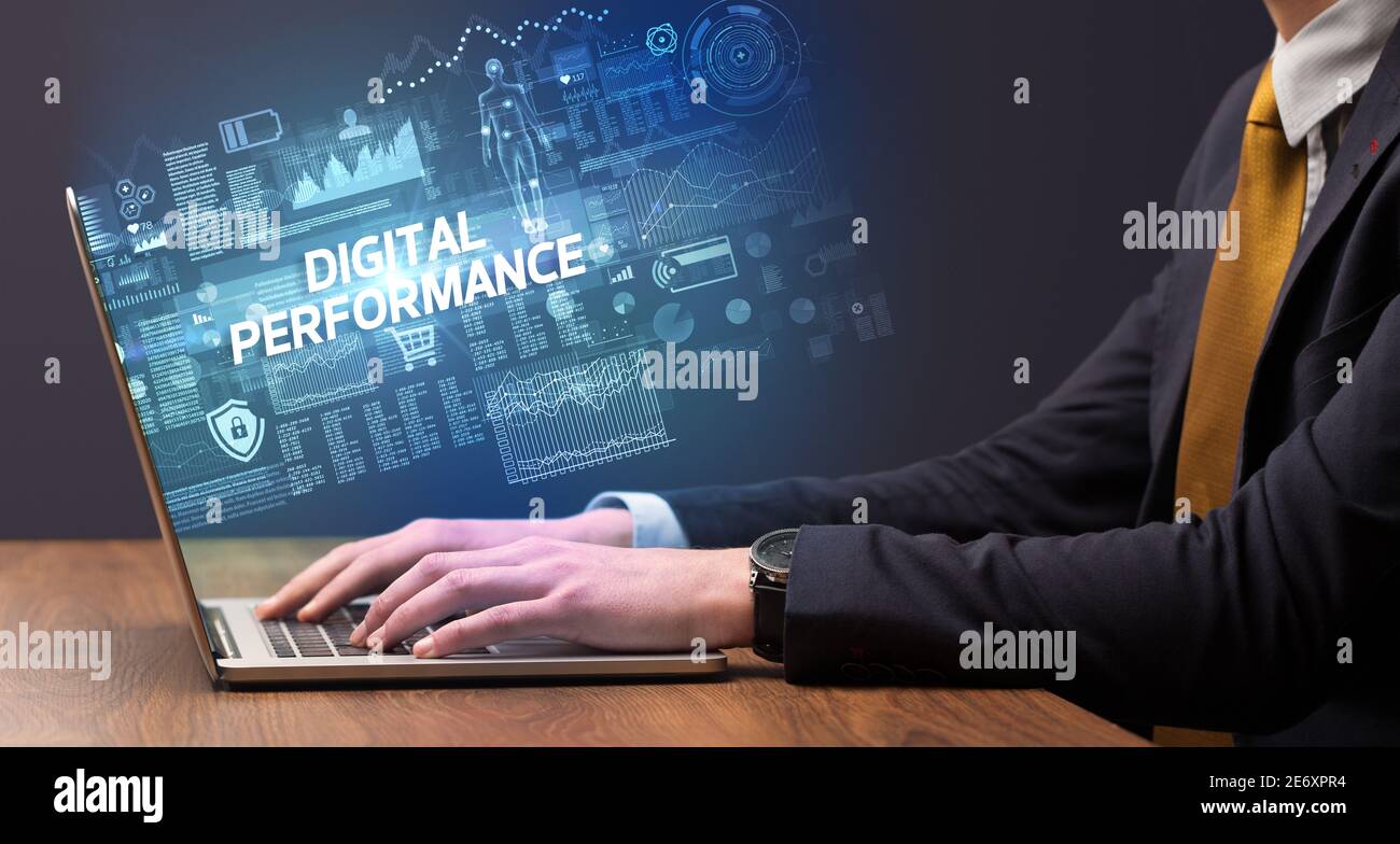 Businessman working on laptop with DIGITAL PERFORMANCE inscription ...