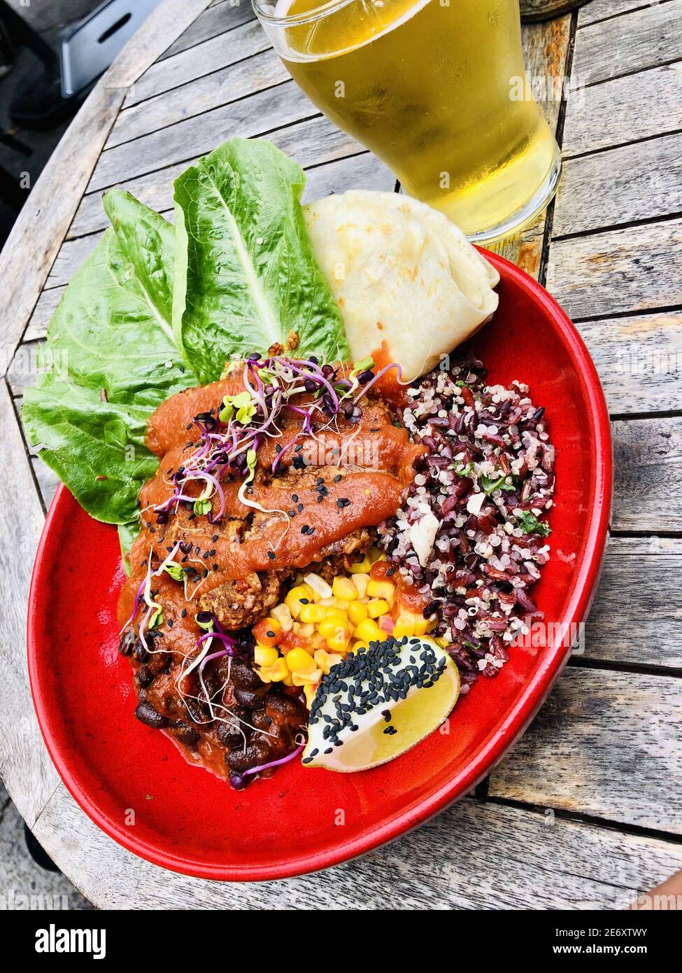 A vertical shot of healthy food dish with a glass of beer on the side ...