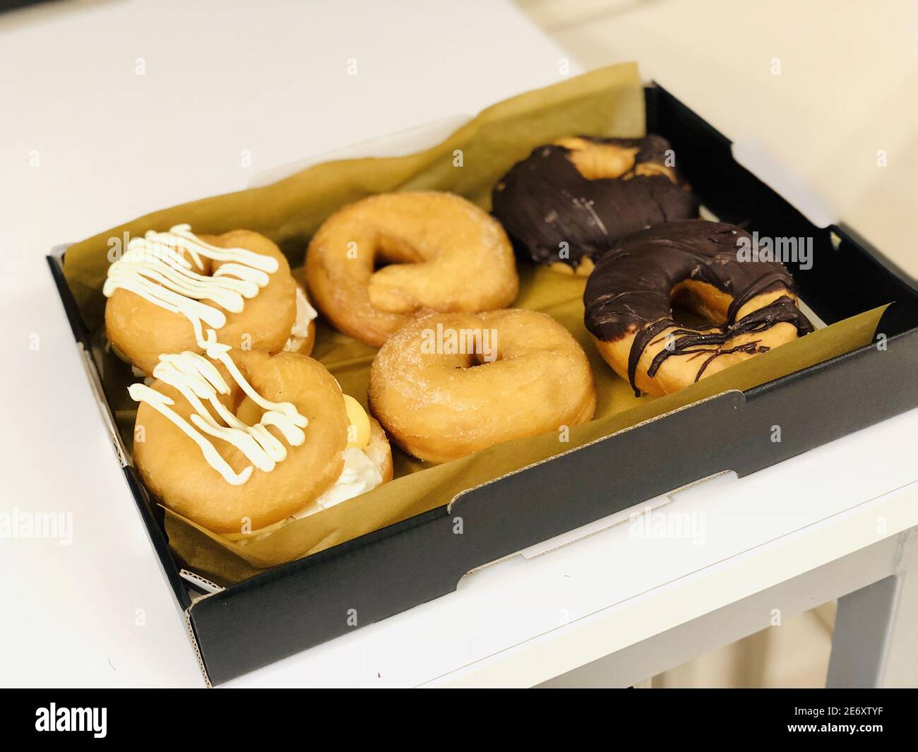 A delicious fresh donuts with chocolate on it placed on a box Stock ...