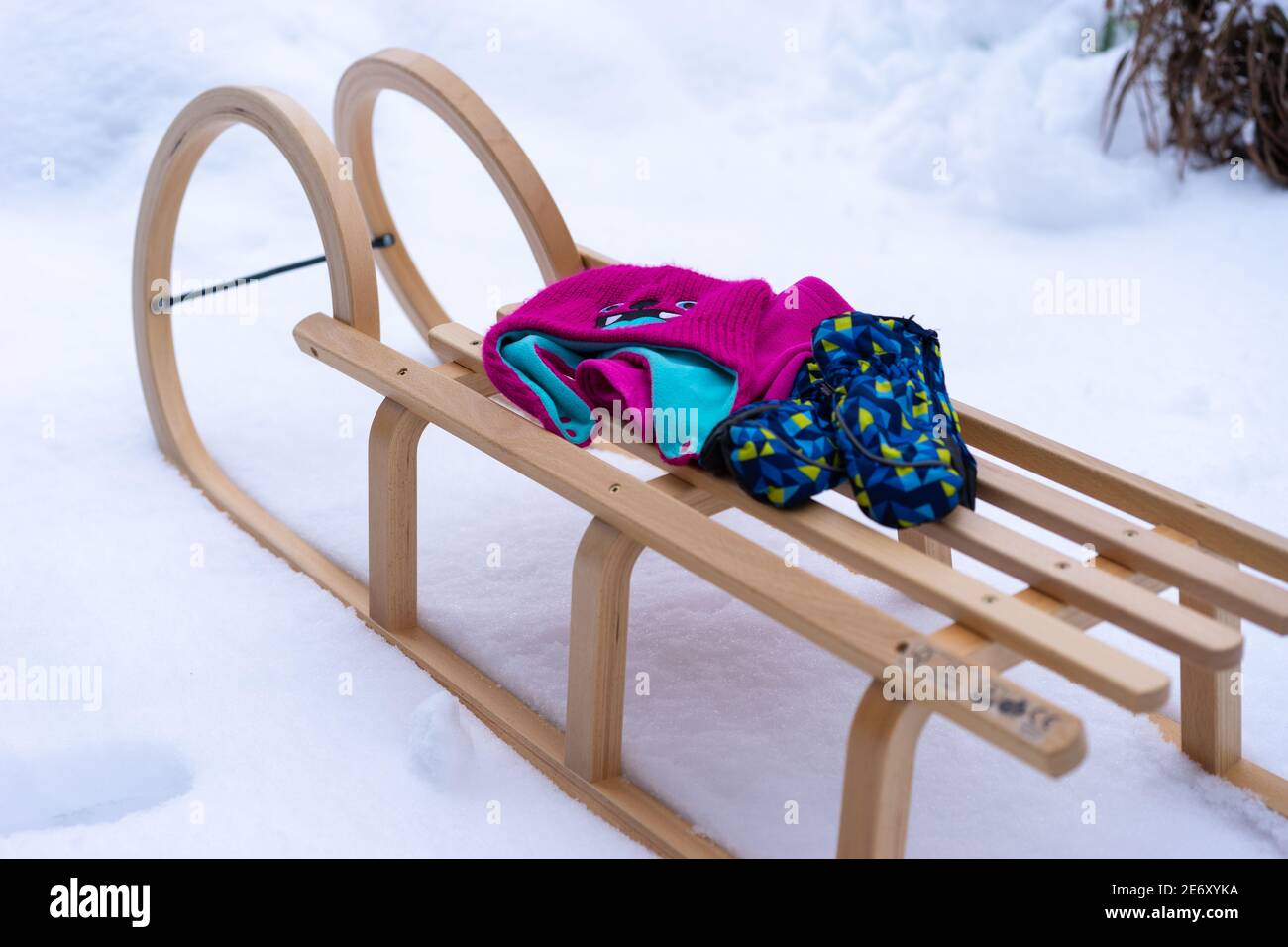 Wood sled set in the snow with winter accessories Stock Photo - Alamy