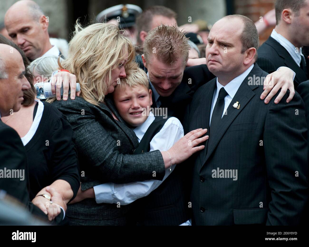 Mourners weep at the funeral hi-res stock photography and images - Alamy