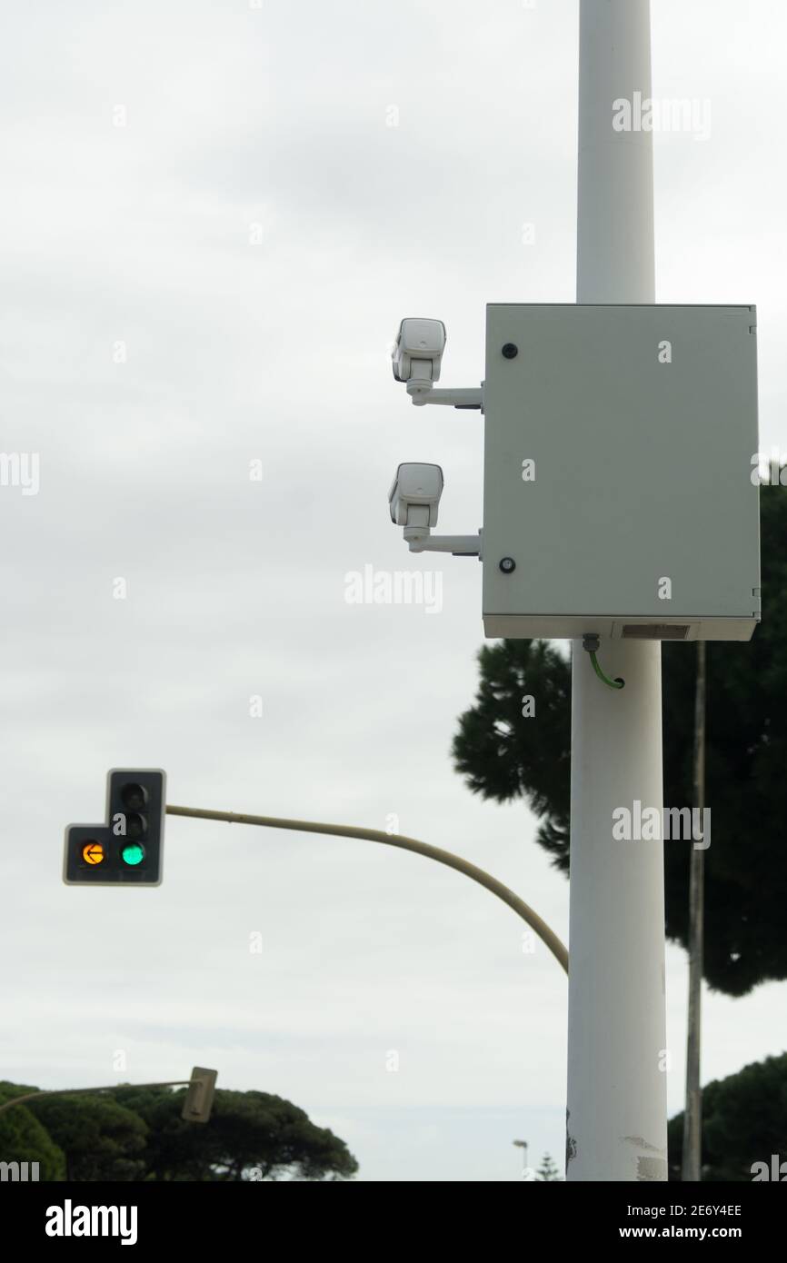Vertical shot of a traffic camera on blurred background of a stoplight ...