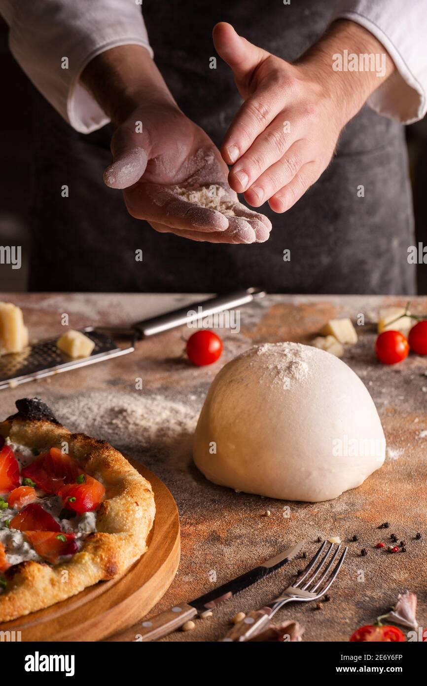 Chef preparing pizza dough at home or in the kitchen Stock Photo - Alamy