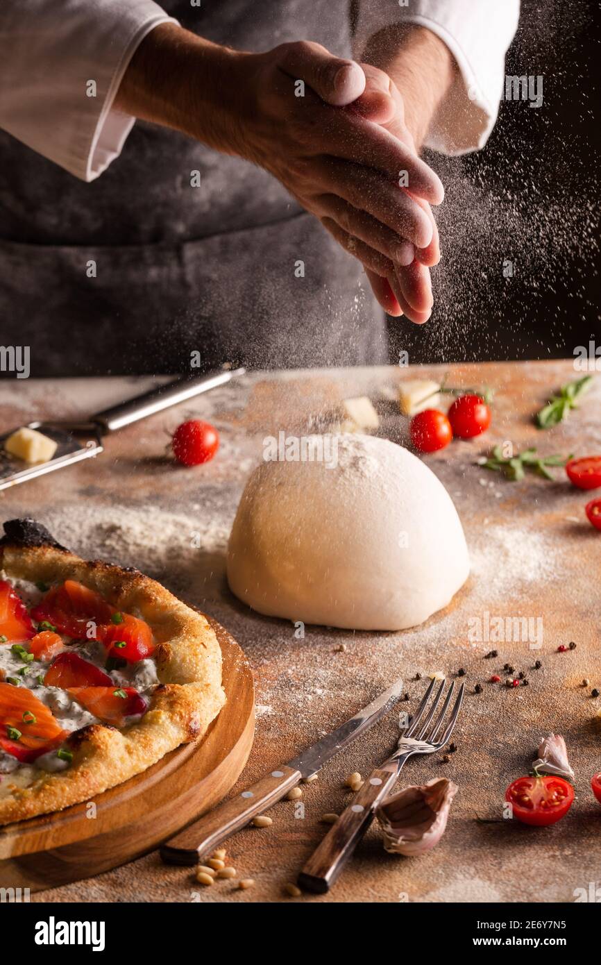 Chef preparing pizza dough at home or in the kitchen Stock Photo - Alamy