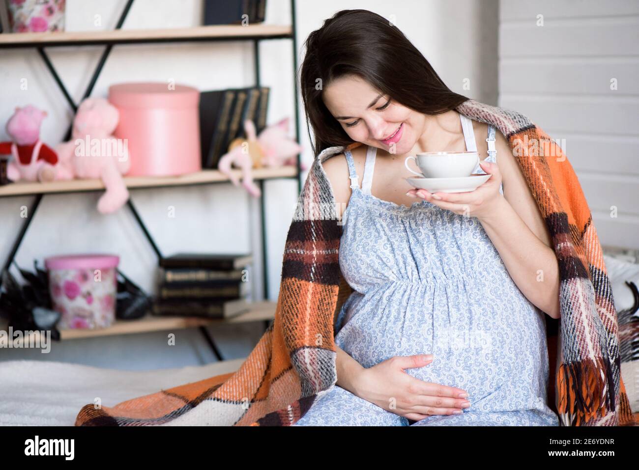Pregnant woman drinking tea in bed at home Stock Photo - Alamy