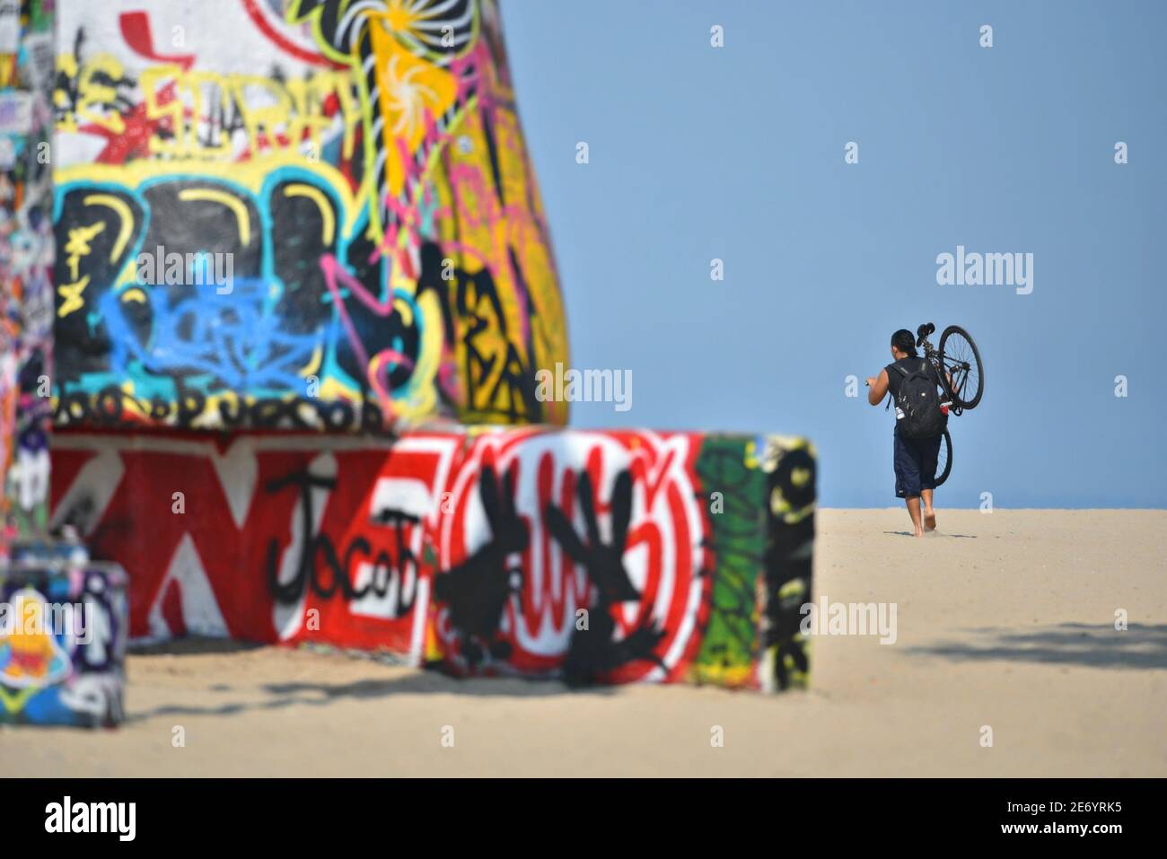 Landscape with a young male athlete carrying his BMX bicycle on the ...
