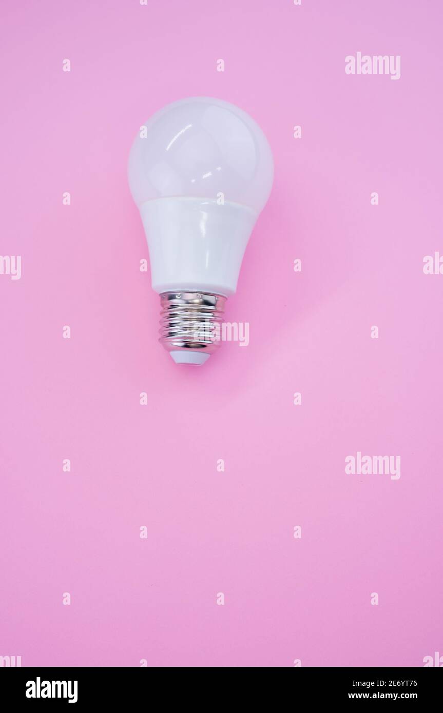 Vertical high angle shot of a lightbulb on a pink surface Stock Photo ...