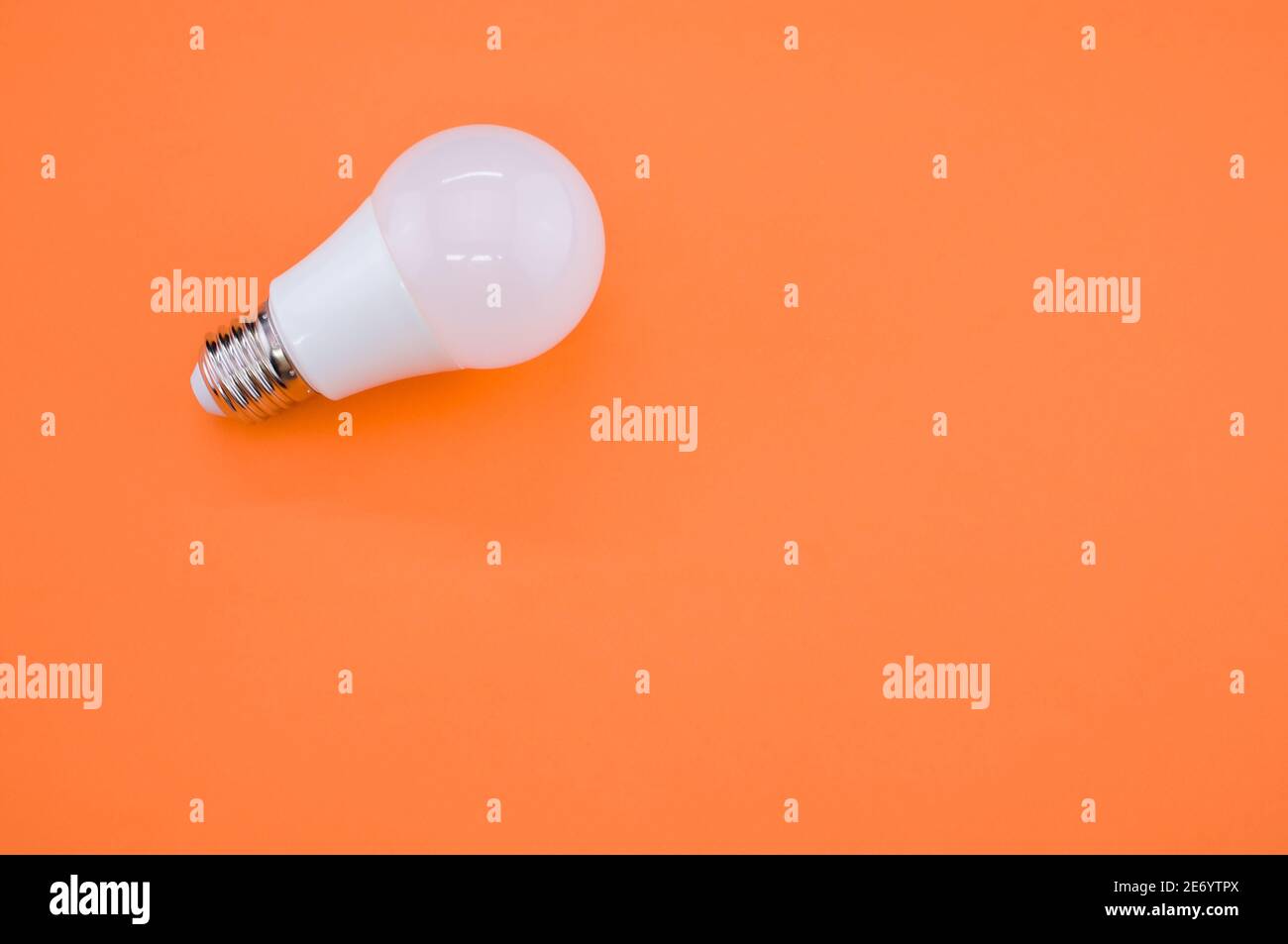High angle shot of a lightbulb on an orange surface Stock Photo - Alamy