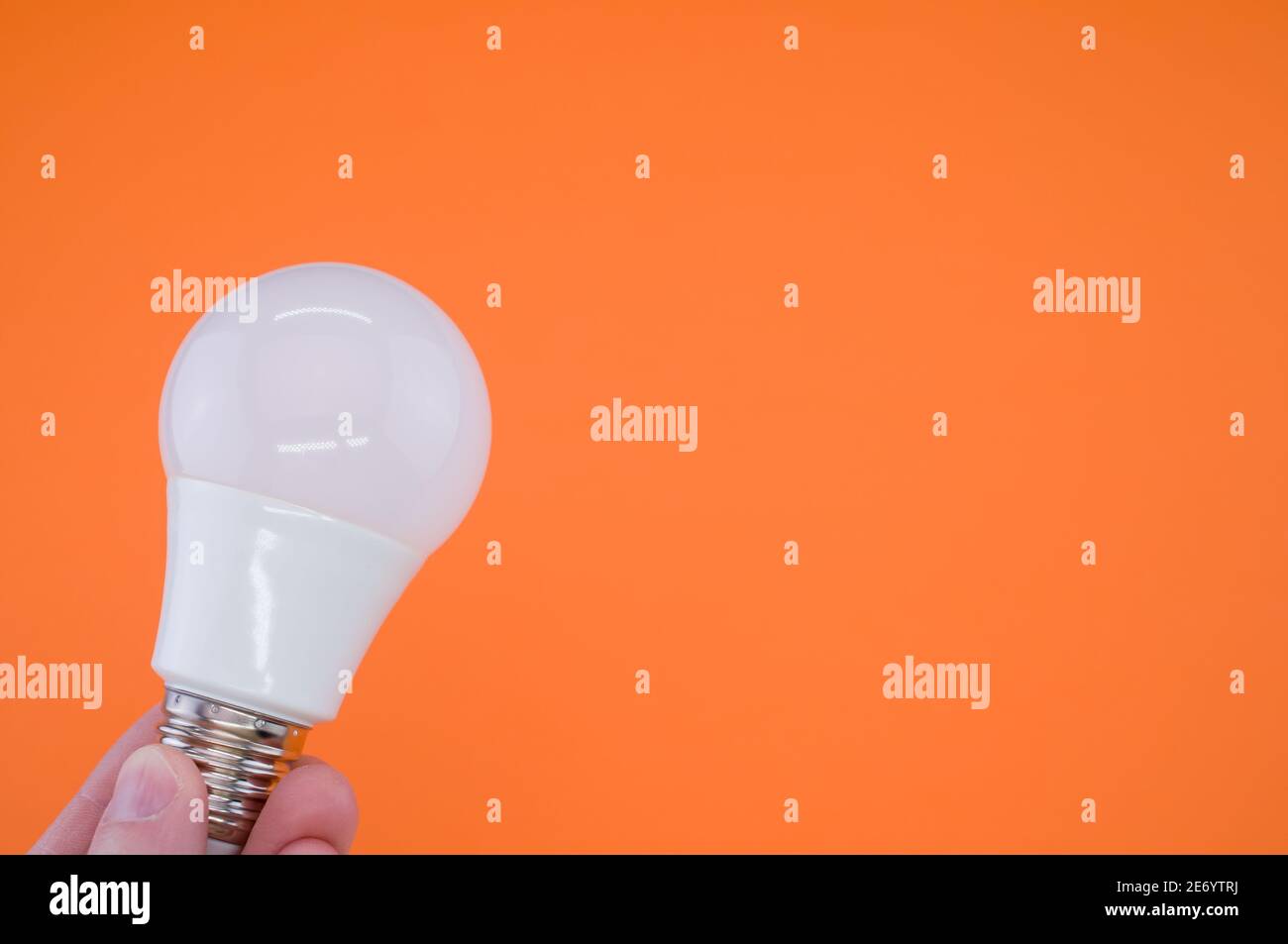 High angle shot of a lightbulb on an orange surface Stock Photo - Alamy