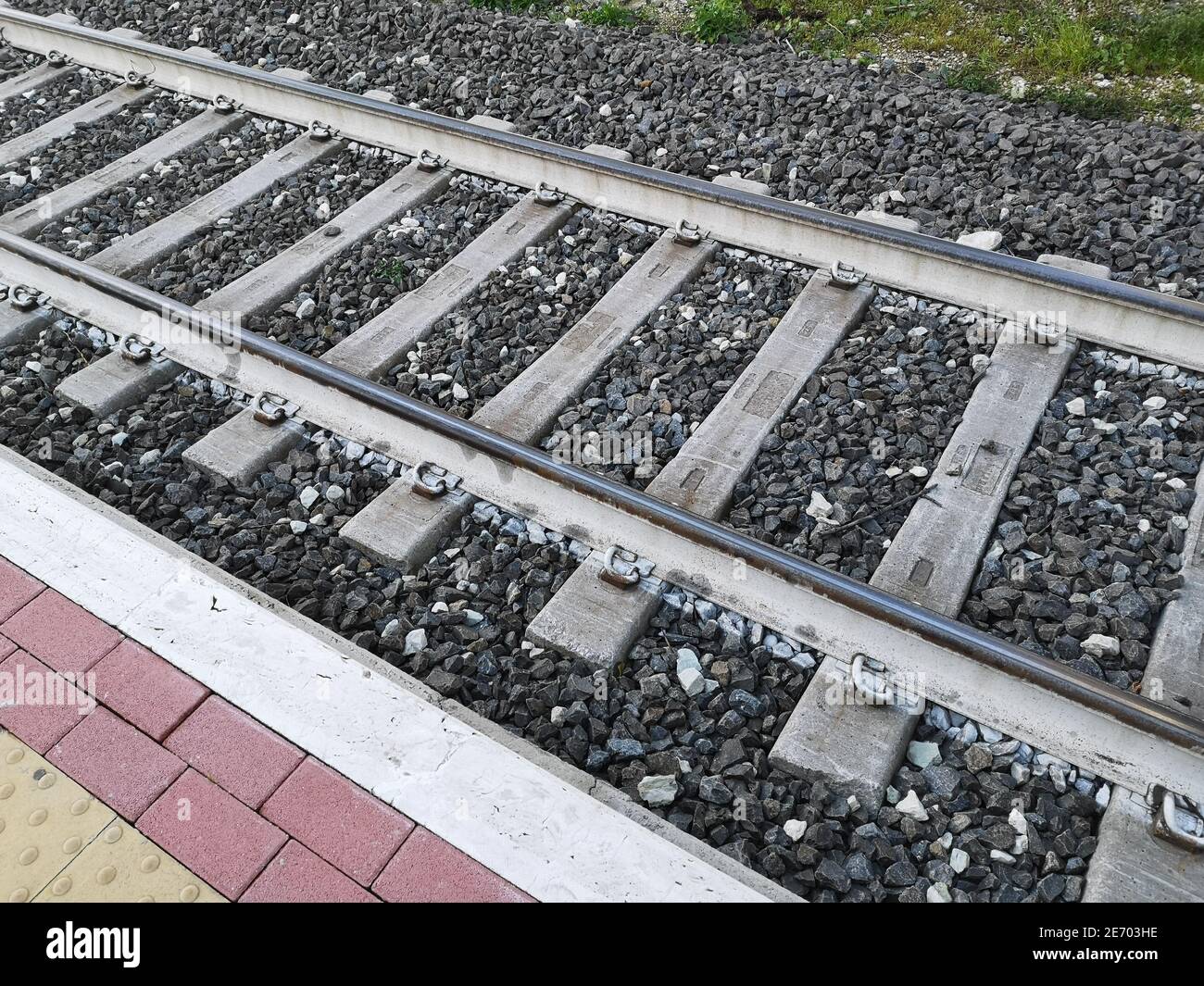 Train tracks with tiny pebbles at daytime Stock Photo - Alamy