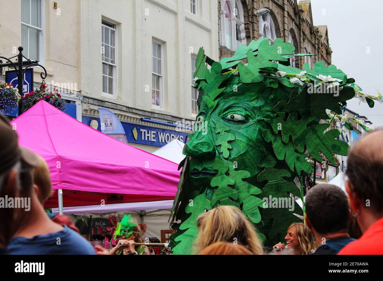 A puppet of a green head covered in leaves in the Mazey day parade as ...